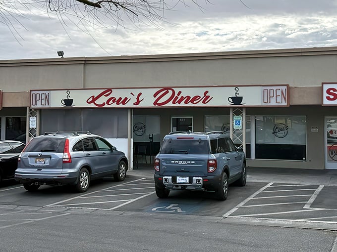 Lou's Diner's unassuming strip mall exterior is like finding a treasure chest disguised as a shoebox—the red script promising delicious secrets within.