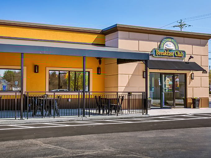 The sunshine-yellow exterior of The Breakfast Club isn't just cheerful—it's practically announcing "morning happiness served here!" Complete with cozy patio seating.