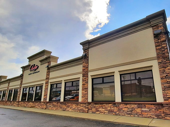 Rudy's exterior blends modern stone with classic comfort, like a cozy sweater wrapped around a five-star meal waiting to happen.