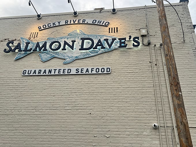The iconic white brick building of Salmon Dave’s promises “GUARANTEED SEAFOOD” — a bold claim they back up daily with maritime flair and coastal confidence.