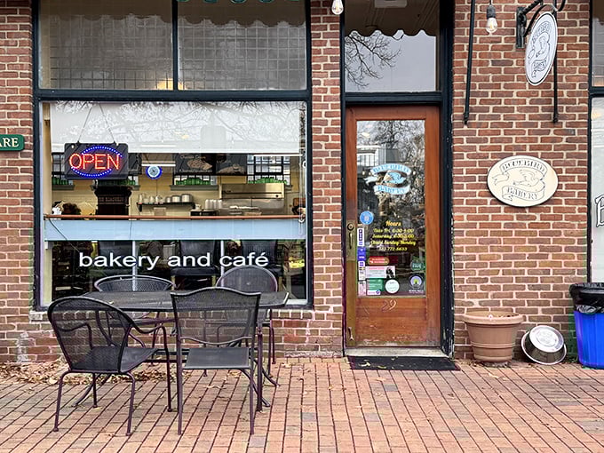 A cozy storefront that promises delicious possibilities, with "bakery and café" proudly displayed beneath an inviting "OPEN" sign that beckons carb enthusiasts.
