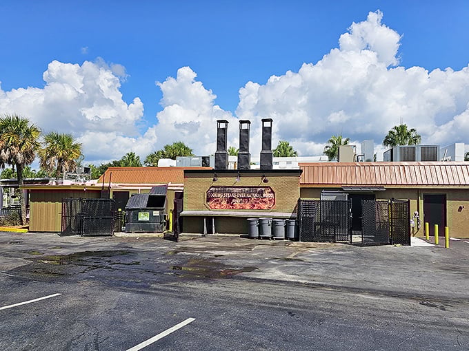 The unassuming exterior of Texas Cattle Company stands like a carnivore's oasis amid Lakeland's palm trees, promising meaty delights behind its rustic wooden façade.