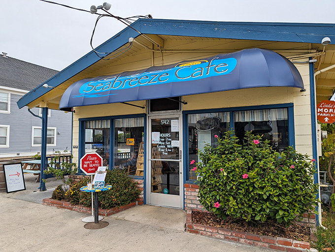 The little blue building with the bright awning isn't trying to impress anyone—until you taste what's coming out of the kitchen.