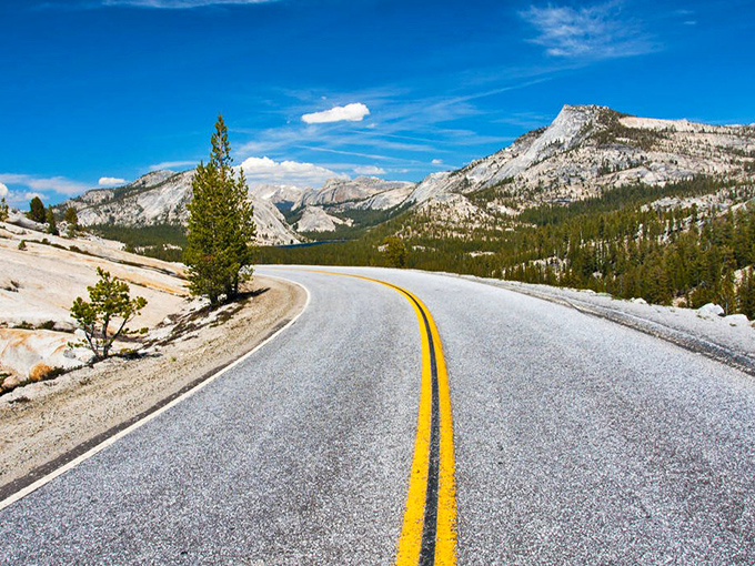 The road to heaven has double yellow lines. Tioga Pass unfurls before you like nature's red carpet, inviting you into a world where granite peaks touch the sky.