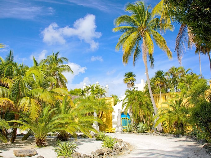 Paradise found: The buttery yellow walls of Bonnet House peek through a jungle of palms, creating a tropical oasis that feels worlds away from nearby beach crowds.
