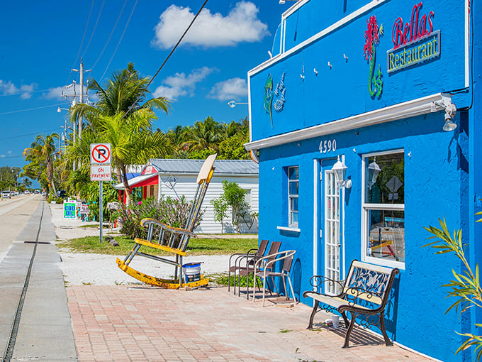 Bella's Restaurant's brilliant blue facade and vintage rocking chair invite you to slow down—this is Old Florida's version of a LinkedIn notification.