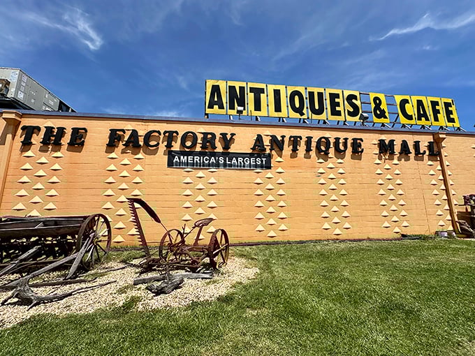 The iconic façade of Factory Antique Mall proudly announces itself as "America's Largest," with vintage farm equipment setting the nostalgic tone before you even step inside.