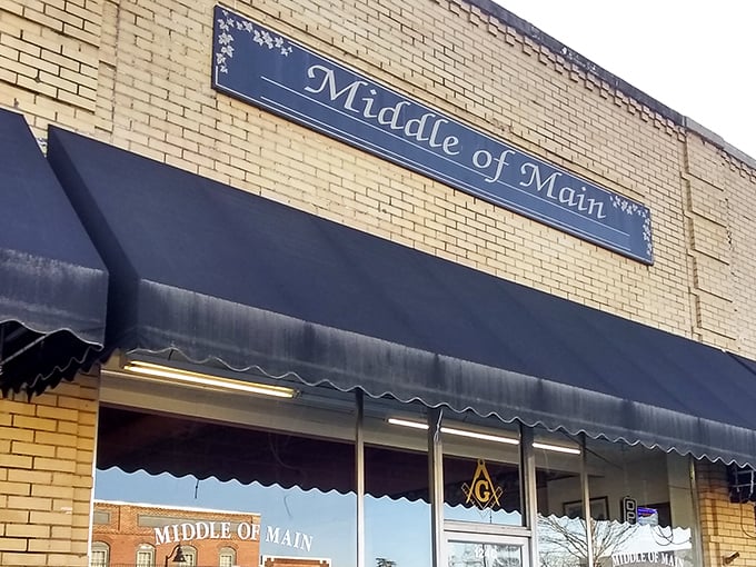 The inviting yellow brick façade of Middle of Main beckons treasure hunters with its classic navy awnings and small-town charm.