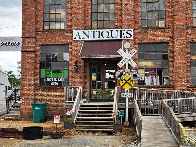 The brick fortress of Relics Antique Marketplace stands proudly in Tupelo, complete with railroad crossing sign—a perfect sentinel for this time-traveling emporium.