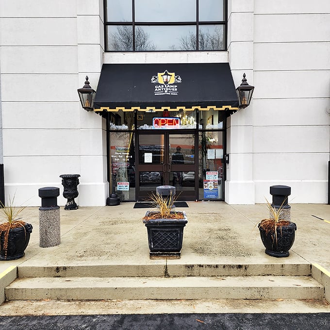 The elegant entrance to GasLamp Antiques beckons with classic black awning and vintage lanterns—like a sophisticated time portal waiting to be opened.