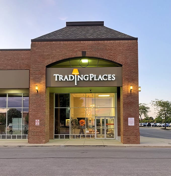 The brick facade of Trading Places glows invitingly at dusk, like a treasure chest waiting to be opened by savvy shoppers.