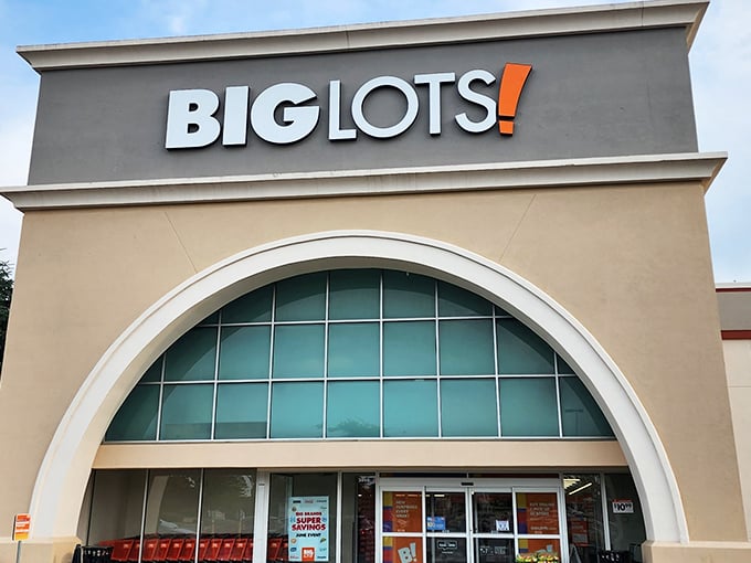 The iconic Big Lots storefront in Kettering beckons with its distinctive arched entrance—like a cathedral dedicated to the religion of savings.