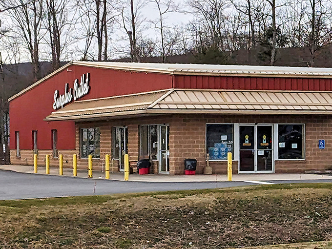 The unassuming red exterior of Surplus Outlet stands like a beacon of bargains against Pennsylvania's rolling hills. Treasure awaits inside!