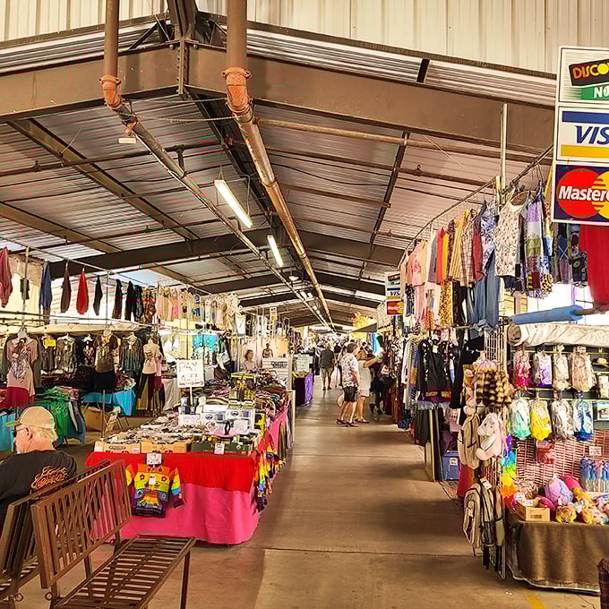 Treasure hunters navigate the covered corridors of Mesa Market Place, where vibrant stalls burst with colorful merchandise and the promise of unexpected discoveries.