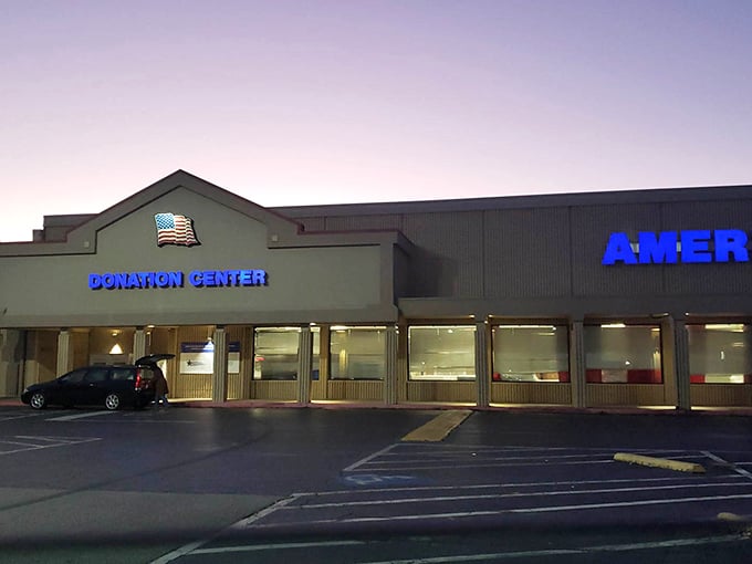 The glowing blue signage of America’s Donation Center shines like a beacon, guiding givers and bargain-seekers alike to where generosity meets treasure.