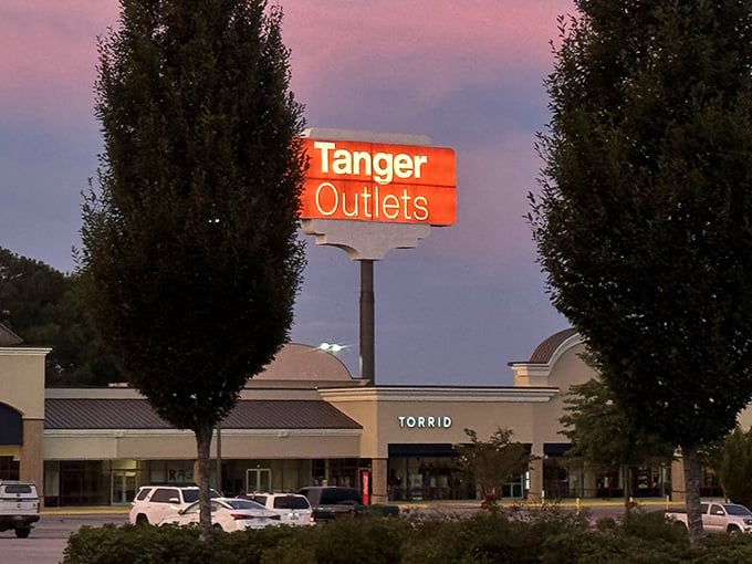 The retail promised land awaits! Under Armour's prominent signage beckons shoppers to the athletic wear paradise at Tanger Outlets Commerce.