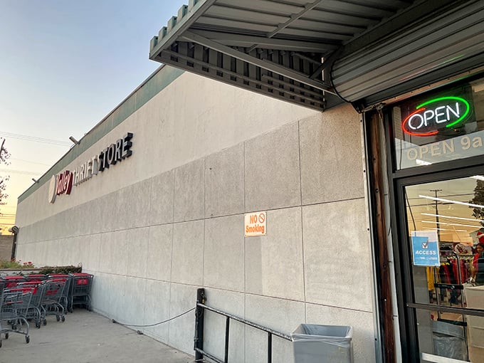 A glowing neon “Open” sign welcomes visitors to Valley Thrift Store in Azusa, hinting that something wonderful awaits inside this unassuming treasure chest.