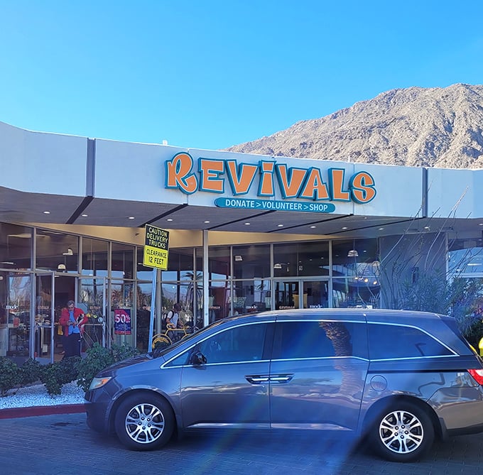 The desert sun illuminates Revivals' iconic storefront, where Palm Springs chic meets thrift store magic against a backdrop of mountain majesty.