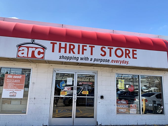 The iconic red awning of arc Thrift Store beckons bargain hunters with its "shopping with a purpose" promise – retail therapy that actually helps others.