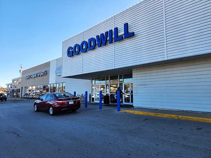 The gleaming white exterior of Omaha's West Center Road Goodwill beckons like a treasure chest waiting to be unlocked. Blue lettering promises adventures in thrifting.
