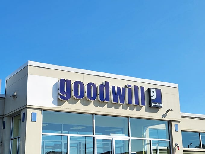 Under bright blue skies, Manchester’s Goodwill—with its bold blue logo—hides a treasure trove behind its unassuming exterior.