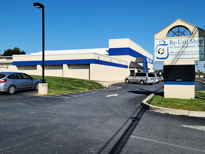 The blue and beige exterior of Re-Uzit Shop beckons like a siren call to bargain hunters, with its welcoming arched entrance promising treasures within.