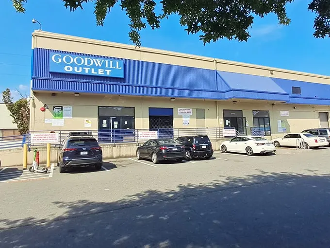 The blue-trimmed facade of Seattle Goodwill Outlet beckons bargain hunters like a siren call to sailors of savings.