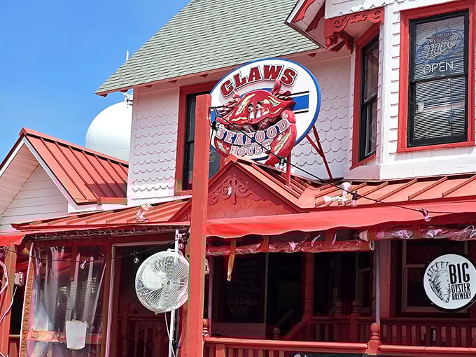 The iconic red and white facade of Claws Seafood House stands as a beacon for crab enthusiasts, its cheerful awnings practically waving you inside.