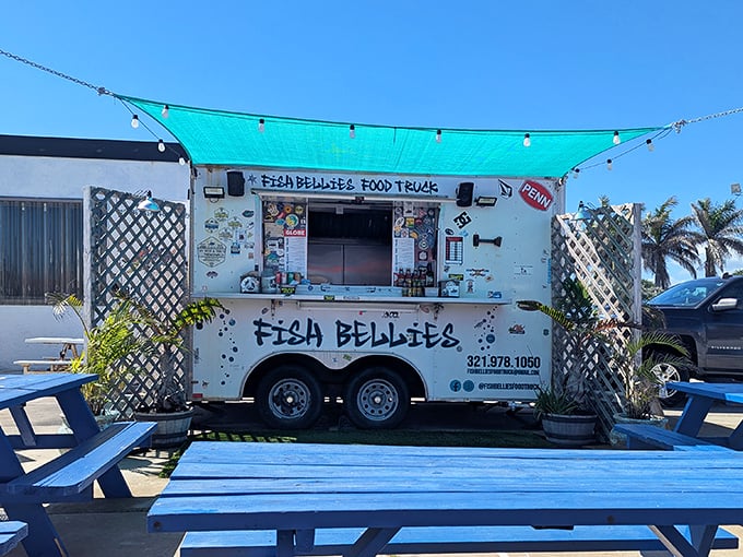 The humble white trailer with its signature turquoise canopy promises seafood magic that belies its unassuming appearance. Florida dining at its most authentic.