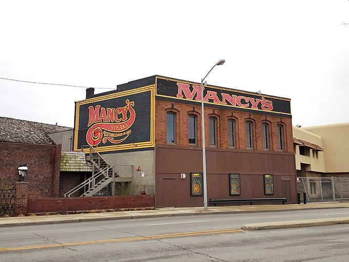 The iconic red Mancy's sign beckons like a lighthouse for hungry souls navigating Toledo's streets. This brick fortress of flavor promises delicious memories inside.