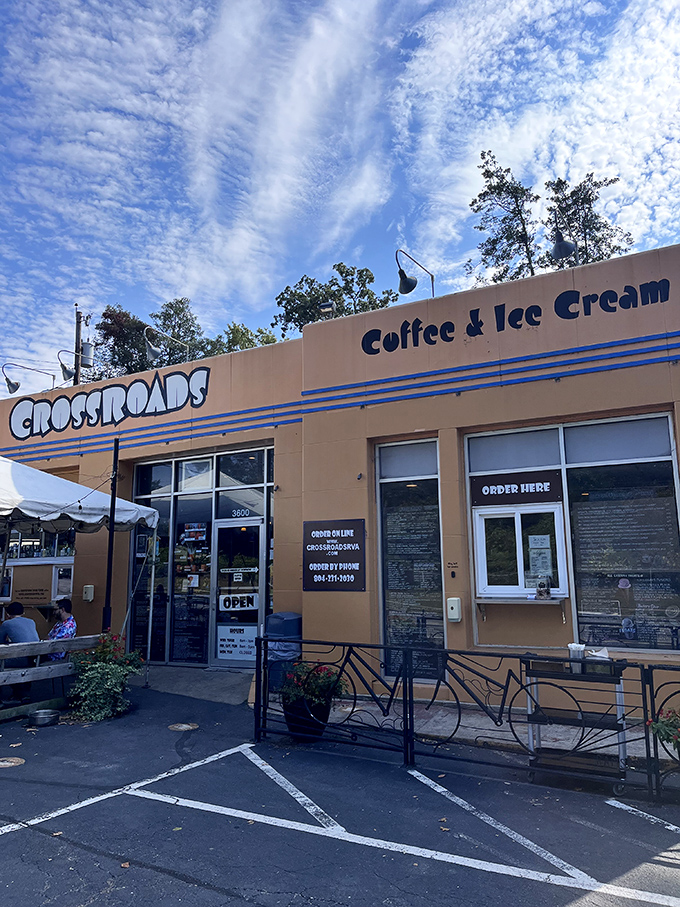 Under Richmond's blue skies, Crossroads welcomes visitors with its cheerful facade—proof that sometimes the best culinary adventures happen in buildings the color of French's mustard.