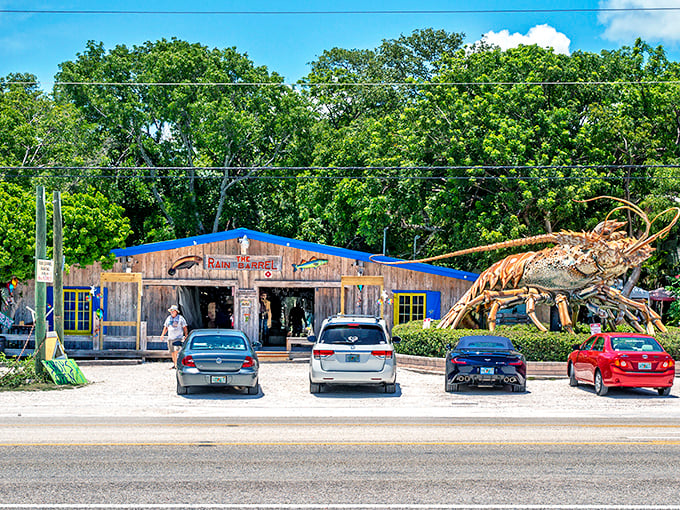The giant lobster stands guard like a crustacean superhero, welcoming visitors to this weathered wooden wonderland of Keys creativity.