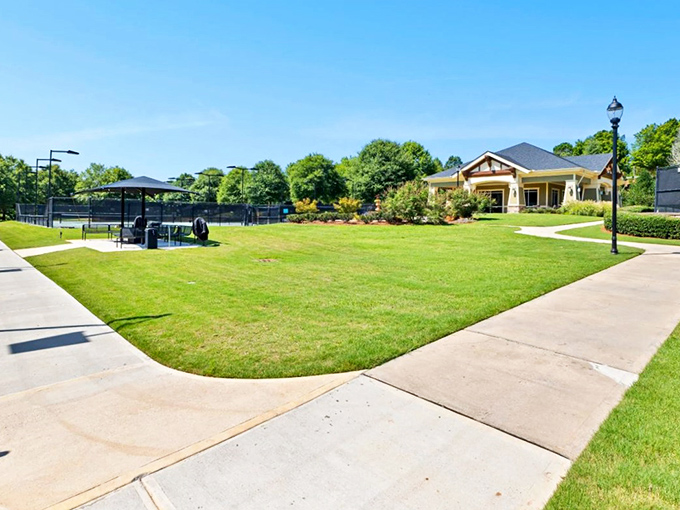 Tennis courts and clubhouse bathed in Georgia sunshine—where retirement means upgrading your backhand, not downgrading your lifestyle.