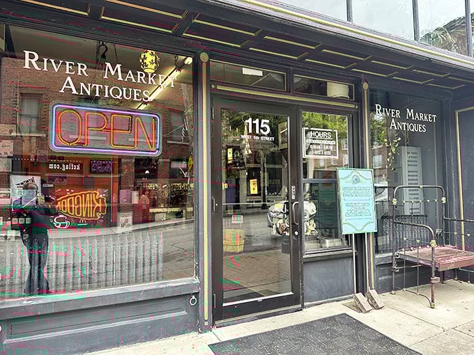 The iconic storefront of River Market Antiques beckons with its glowing neon "OPEN" sign – a portal to treasures waiting to be discovered inside this Kansas City landmark.