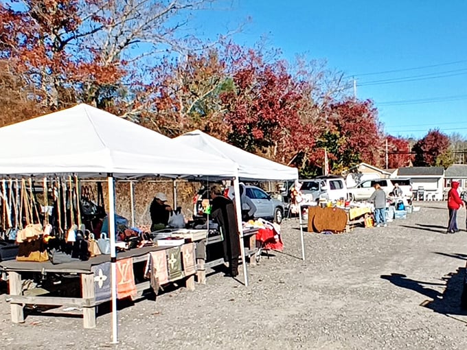 Treasure hunting begins under white tents where autumn leaves provide the perfect backdrop for discovering someone else's "finally getting rid of this" moment.