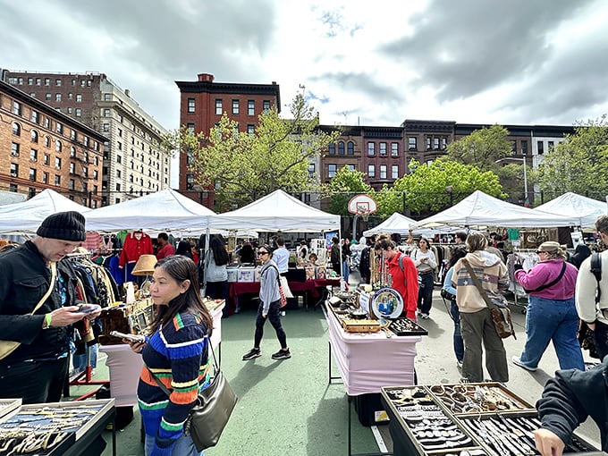 Shoppers weave between tables under the watchful gaze of classic Upper West Side architecture—New York's version of an open-air museum where everything's for sale.