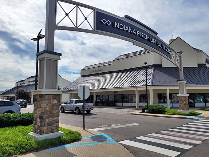 The grand entrance to Indiana Premium Outlets showcases its impressive brand lineup – where your wallet trembles with both fear and excitement.