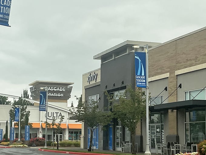 Retail therapy paradise in Portland. This bustling outlet entices shoppers with endless deals, framed by the mall’s storefront and a tree standing gracefully at its side.