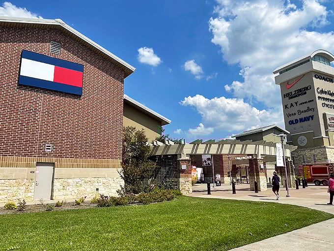The iconic Tommy Hilfiger storefront welcomes shoppers to Houston Premium Outlets, where Texas-sized deals await behind that familiar red, white, and blue logo.