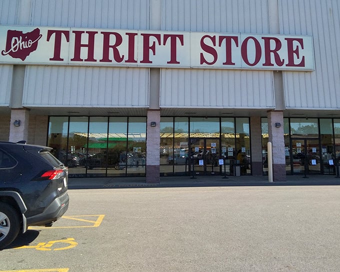 The iconic red signage of Ohio Thrift Store beckons bargain hunters like a retail lighthouse guiding ships full of empty wallets safely to shore.