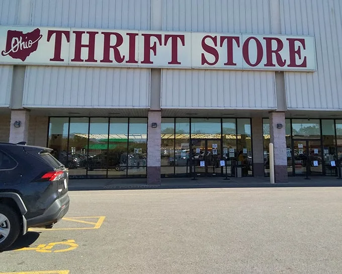 The iconic red signage of Ohio Thrift Store beckons bargain hunters like a retail lighthouse guiding ships full of empty wallets safely to shore.
