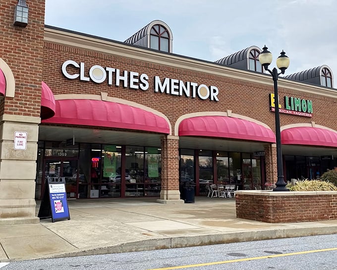 The brick storefront with its cheerful pink awnings promises fashion treasures within—like a beacon for style-seekers on a budget.