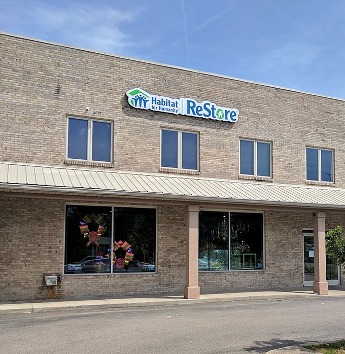 The unassuming brick exterior of Habitat ReStore hides a treasure trove within – like finding a secret passage to bargain paradise.