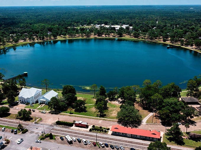 Lake DeFuniak shimmers like a perfect sapphire, surrounded by historic buildings and lush greenery – Mother Nature's own retirement community centerpiece.