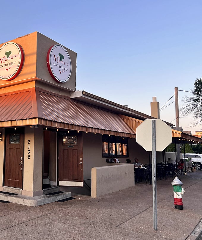 Bathed in golden sunset light, Mama's welcoming façade promises the authentic flavors of Italy with its distinctive signage and cozy outdoor seating area.