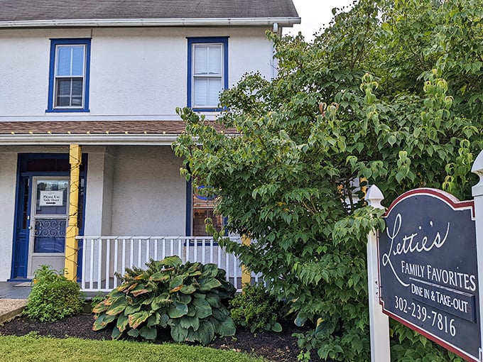 The charming white farmhouse with blue trim isn't just picturesque – it's housing some of Delaware's most comforting cuisine. Home is where the pie is.