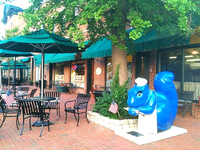 The charming brick exterior of Bluebird Bakery welcomes you with turquoise umbrellas and a whimsical blue squirrel sculpture—Cincinnati's tastiest woodland creature.