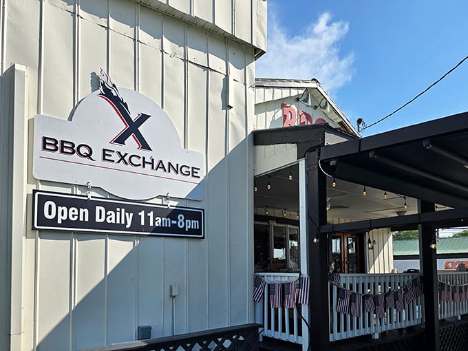 The unassuming white exterior of BBQ Exchange belies the smoky treasures within. That "Open Daily" sign might as well read "Enter Barbecue Paradise."