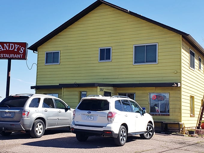 The sunshine-yellow exterior of Sandy's isn't just a building—it's a breakfast beacon calling to hungry souls across Colorado Springs.