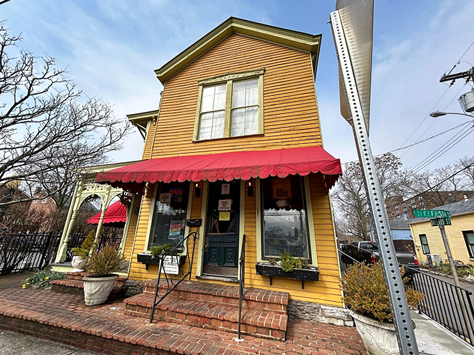 The mustard-yellow Victorian house with its welcoming red awning stands like a culinary lighthouse on Jefferson Street, beckoning hungry travelers home